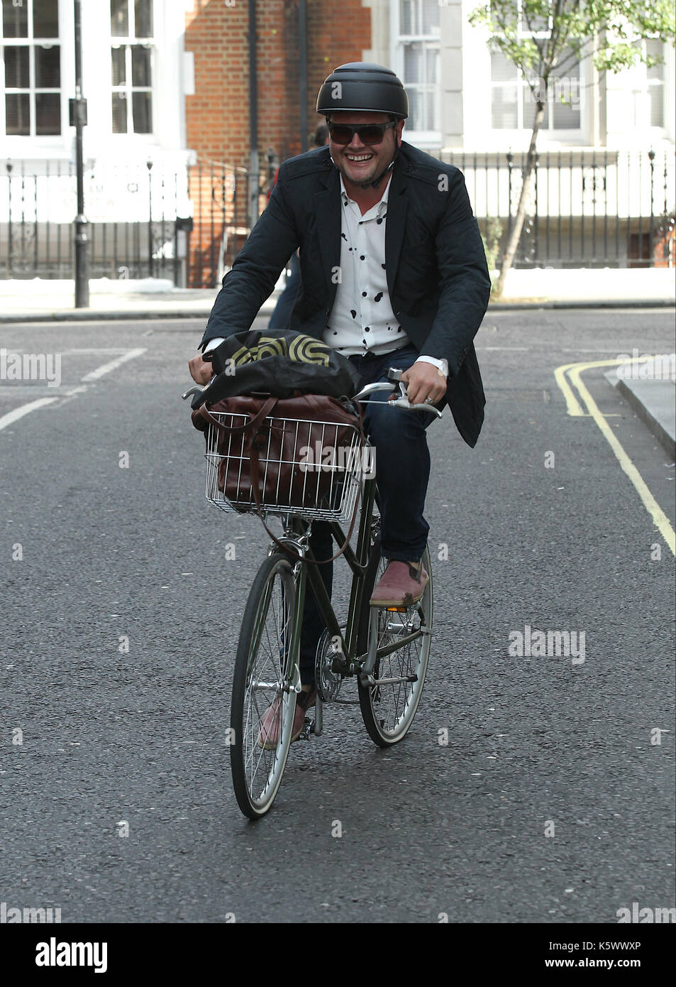 Alan Carr seen leaving the BBC studios on his bicycle in London on 2nd ...