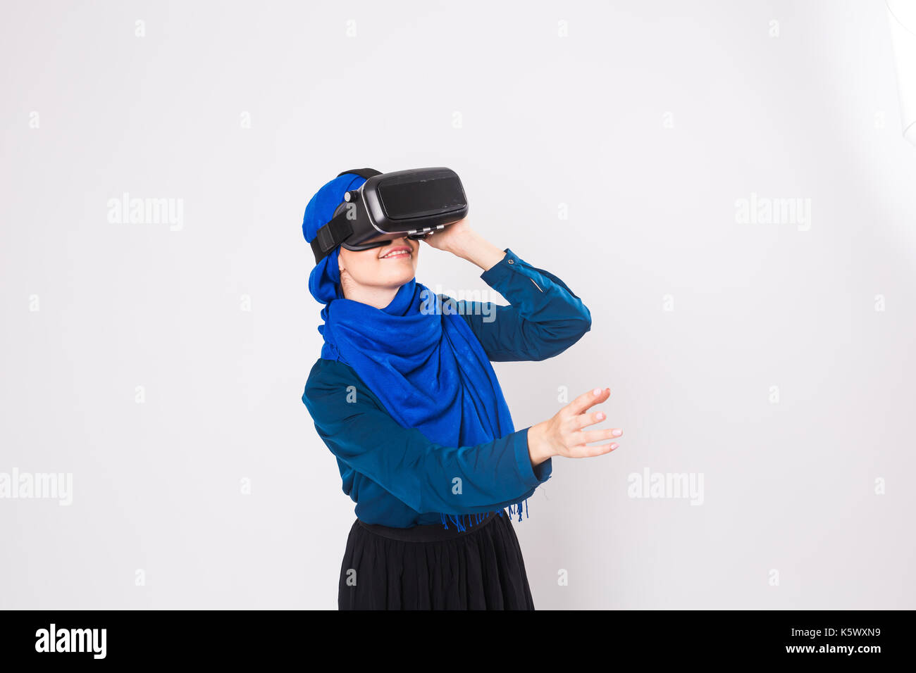 Asian muslim woman wearing hijab using VR headset glasses of virtual ...