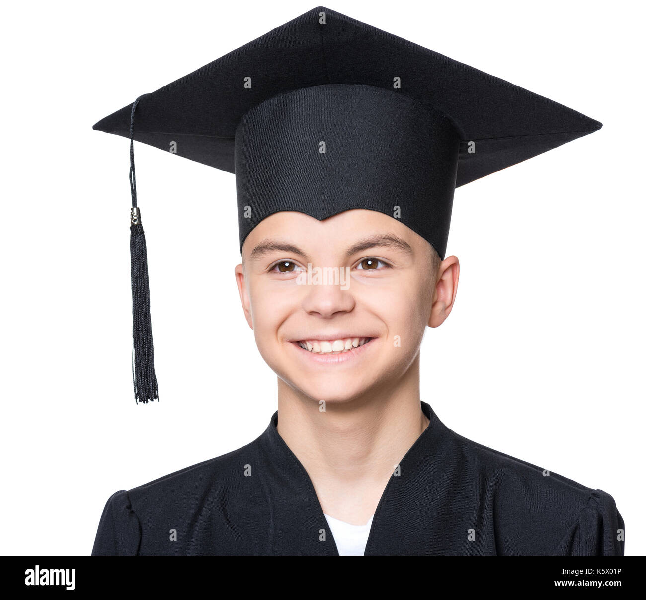 Close up portrait of graduate teen boy student in black graduation gown ...