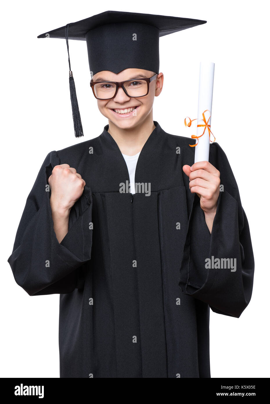 Portrait of graduate teen boy student in black graduation gown with hat ...