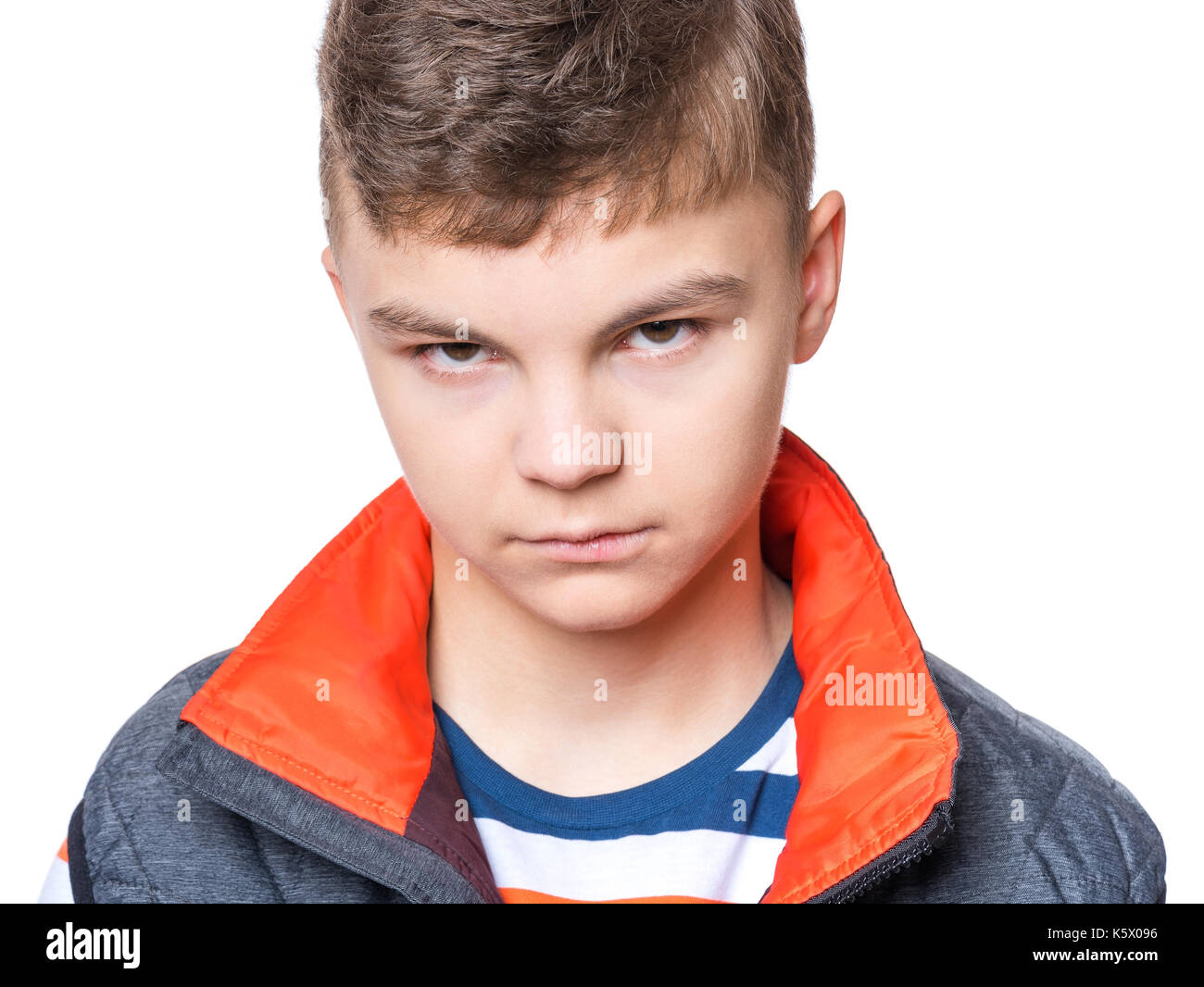Teen boy making silly grimace - expressing disgust face. Upset child ...