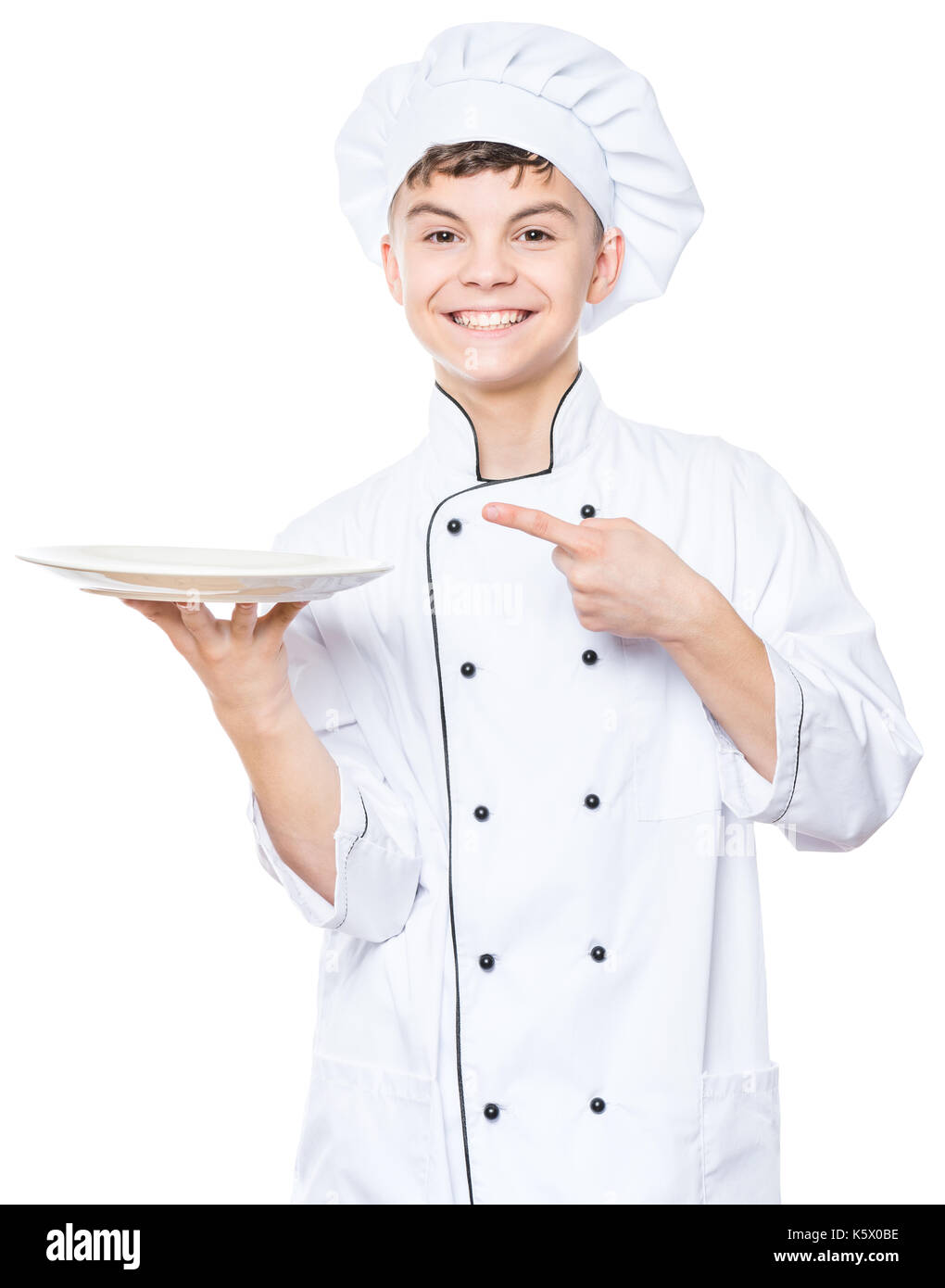 Cheerful handsome teen boy wearing chef uniform. Portrait of a happy ...