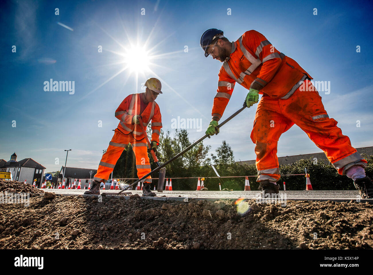 Railway construction workers laying new track Stock Photo - Alamy