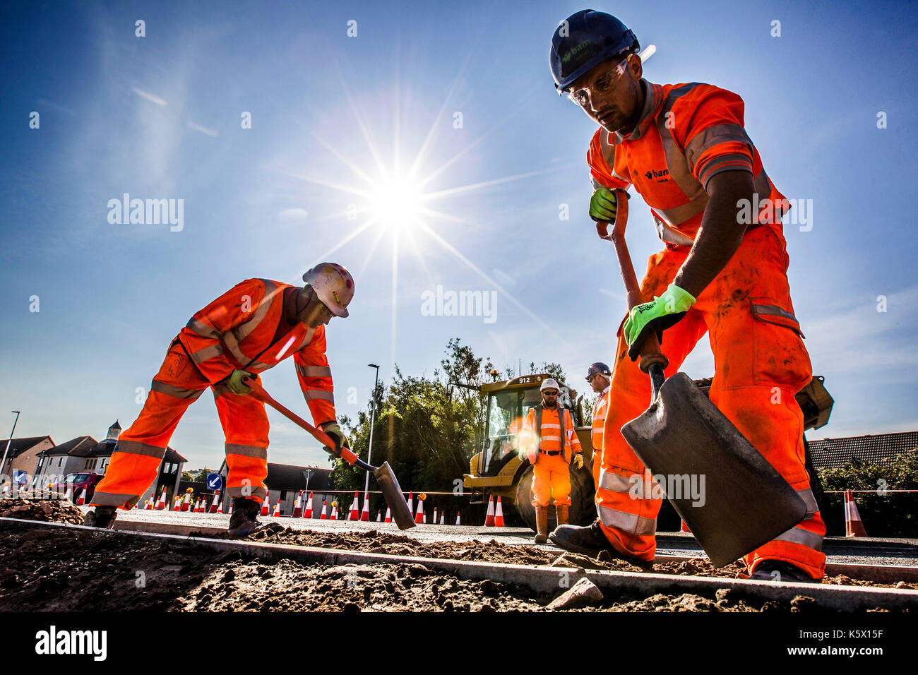 Railway construction workers laying new track Stock Photo - Alamy