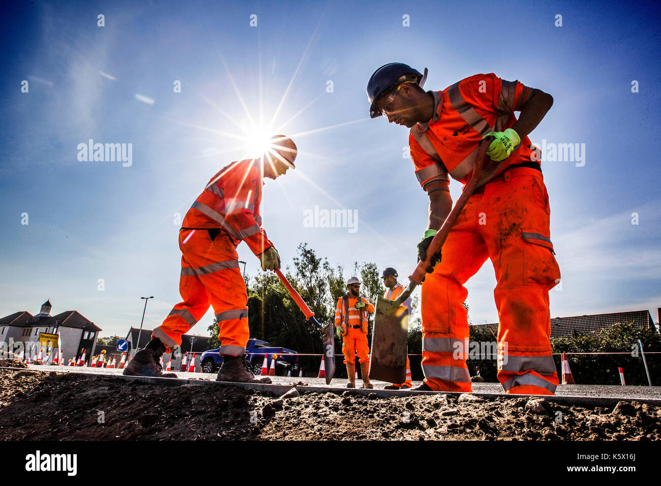 Railway construction workers laying new track Stock Photo - Alamy