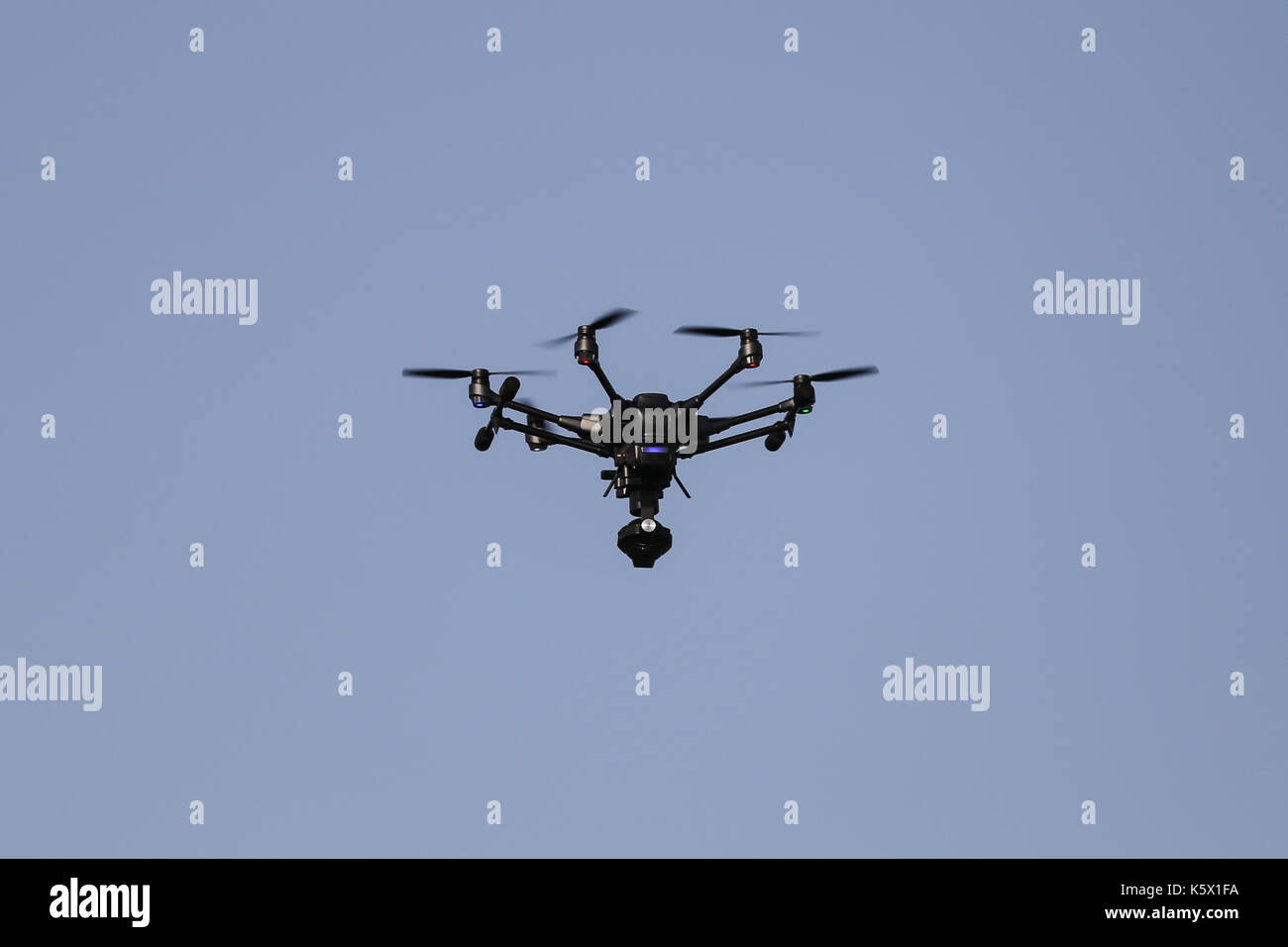 Black hexacopter helicopter is flying in sky Stock Photo - Alamy