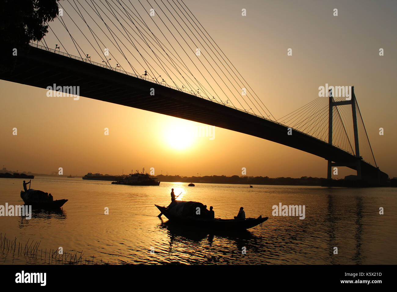 Floating boat on river Stock Photo - Alamy