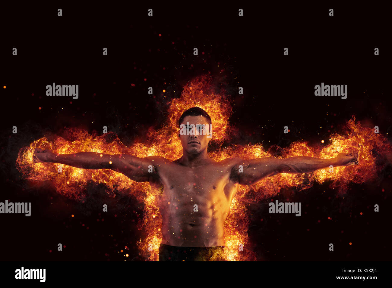 Muscular of a body building trainer with fire Stock Photo - Alamy