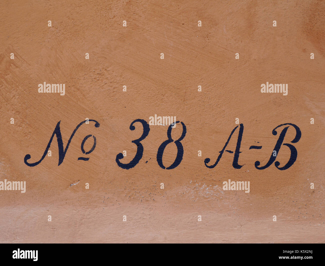 House number 38 A-B on old building. Dark letters on orange / Brown ...