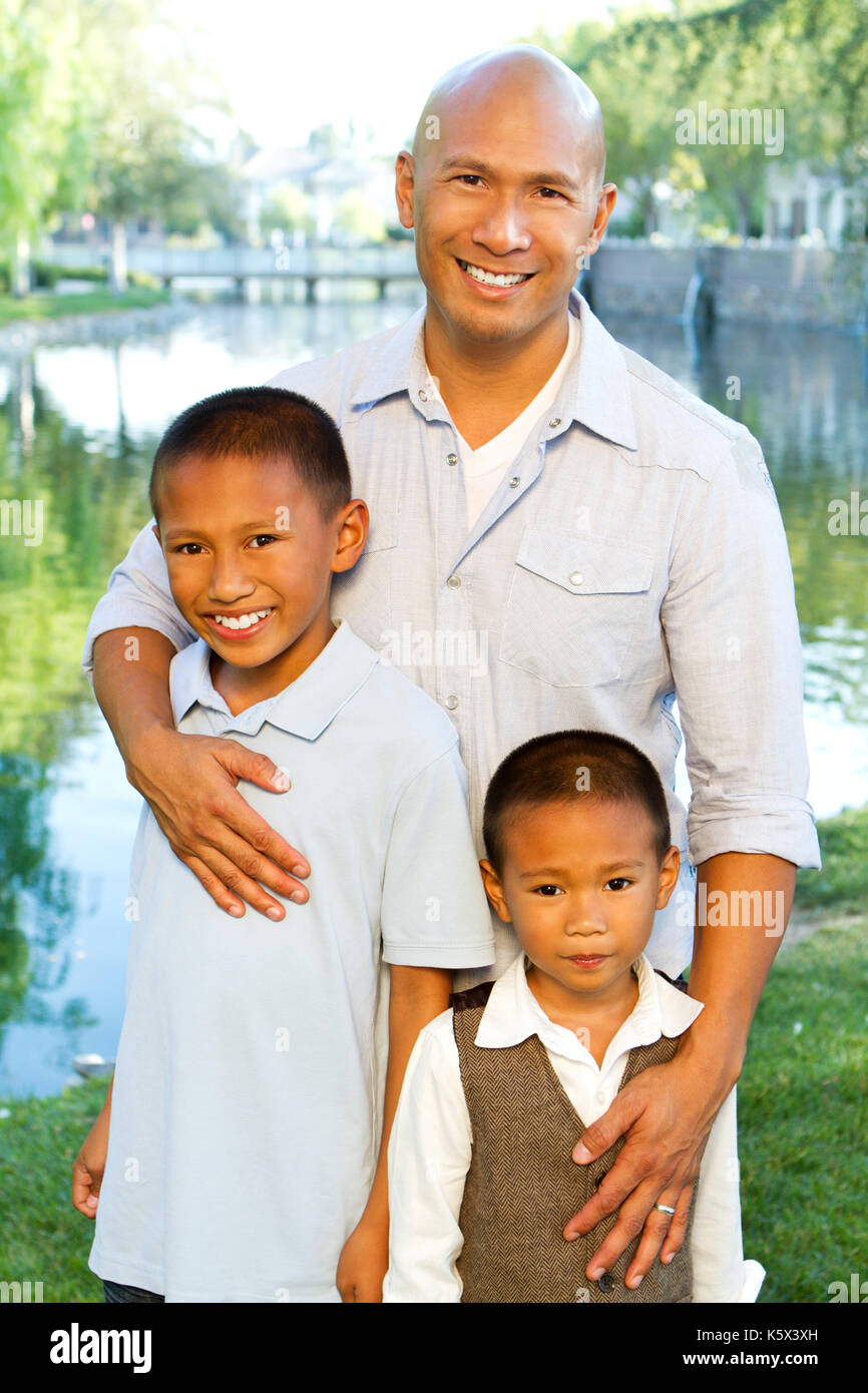 Asian father and his sons Stock Photo - Alamy