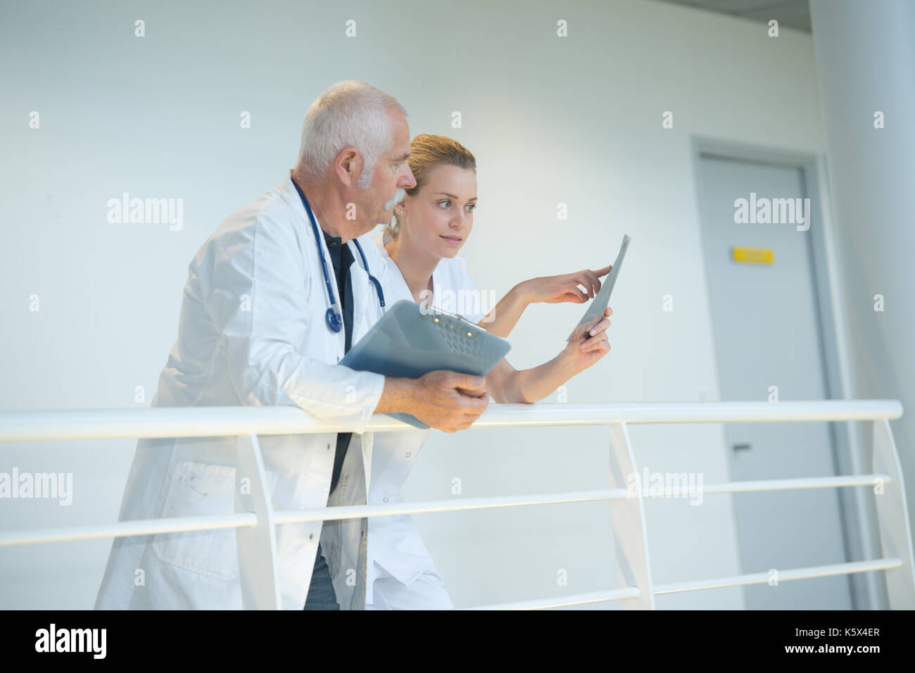 two doctors talking to each other in the corridor Stock Photo - Alamy