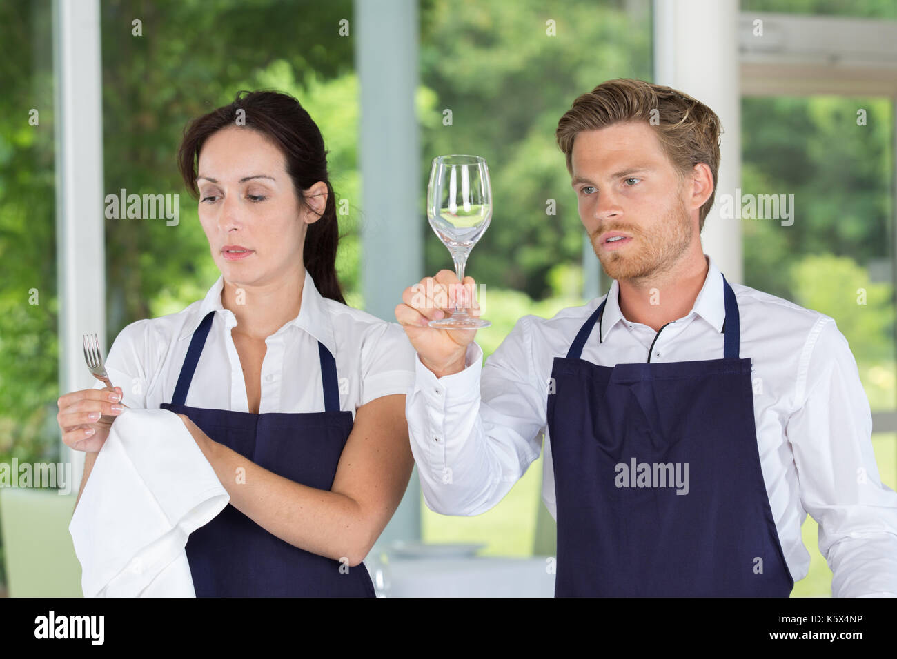 waitress and waiter working in bar Stock Photo - Alamy