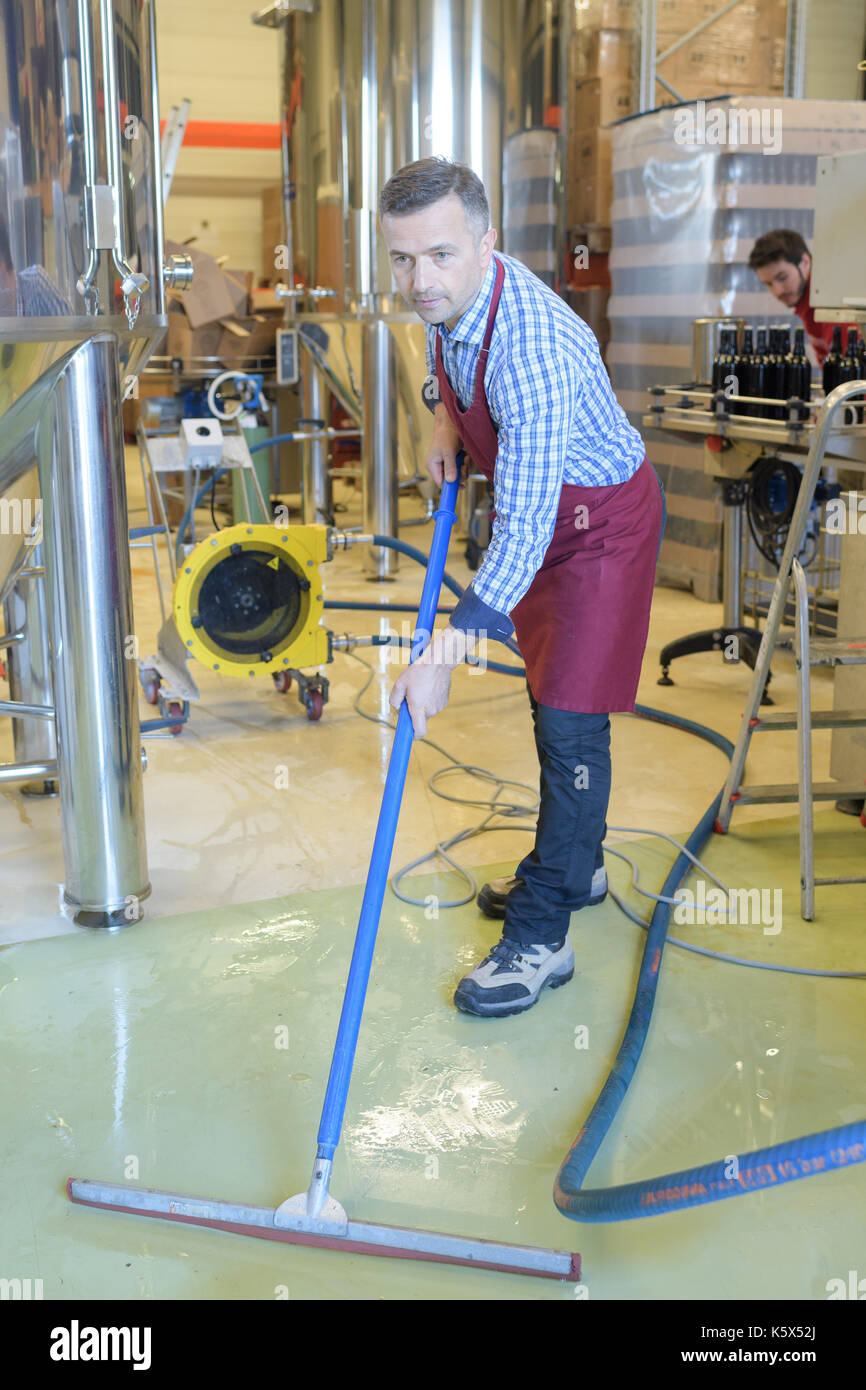 factory worker cleaning floor Stock Photo - Alamy