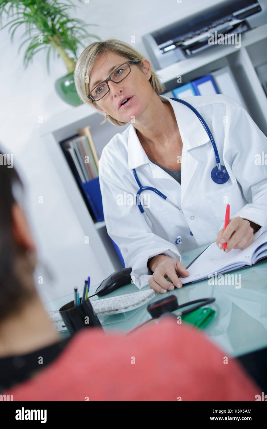 female doctor presenting medical exam results to patient Stock Photo ...