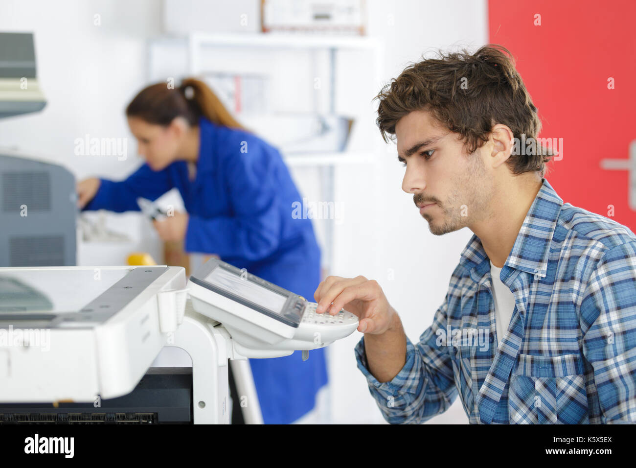 man using control pad on printer Stock Photo - Alamy