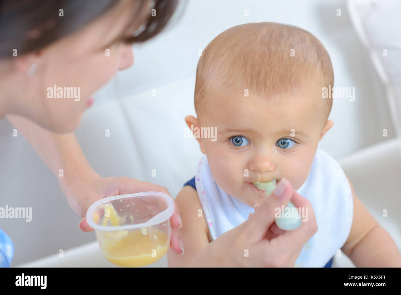 giving food to a baby Stock Photo - Alamy