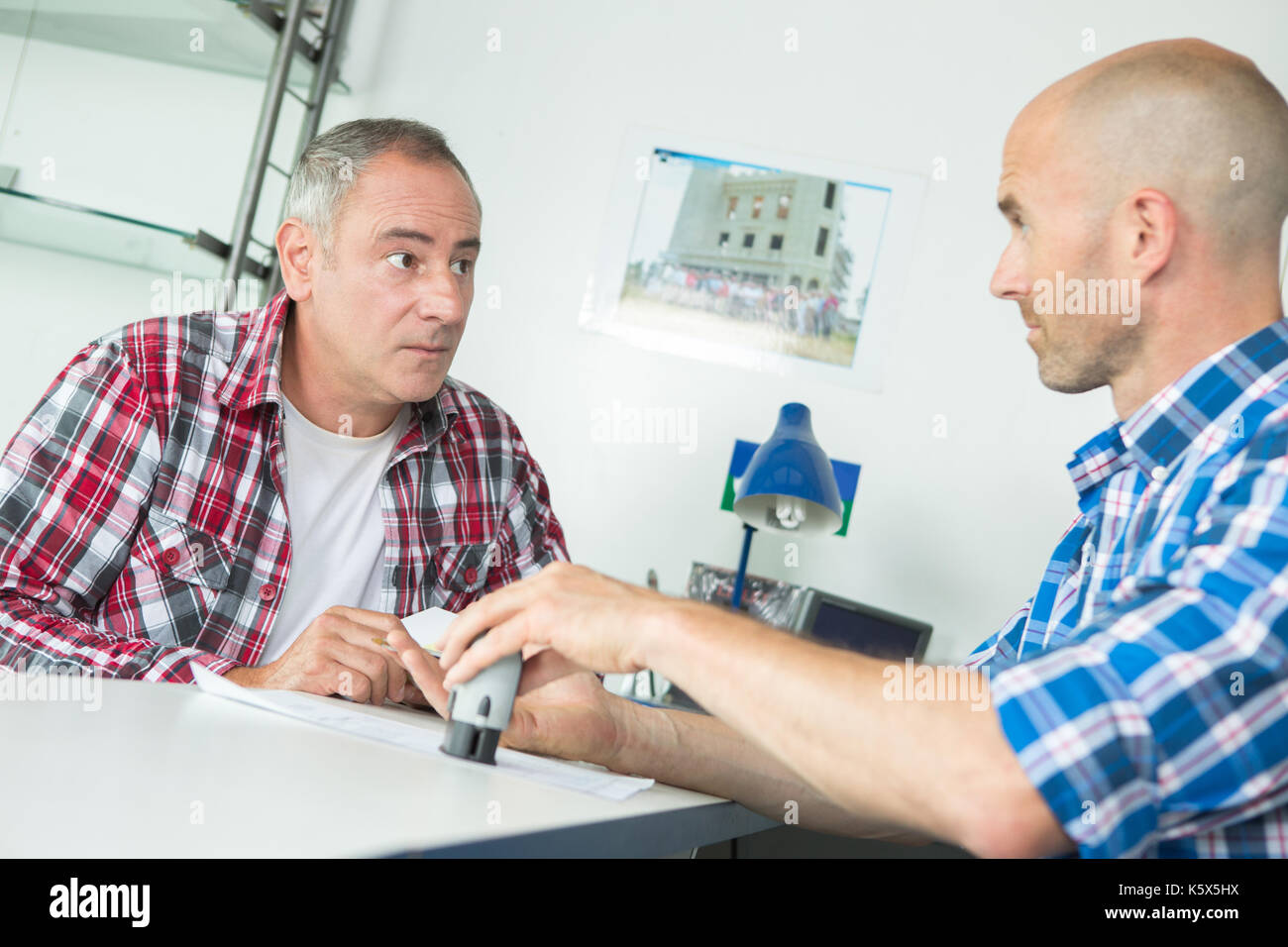 Man stamping customer's receipt Stock Photo - Alamy