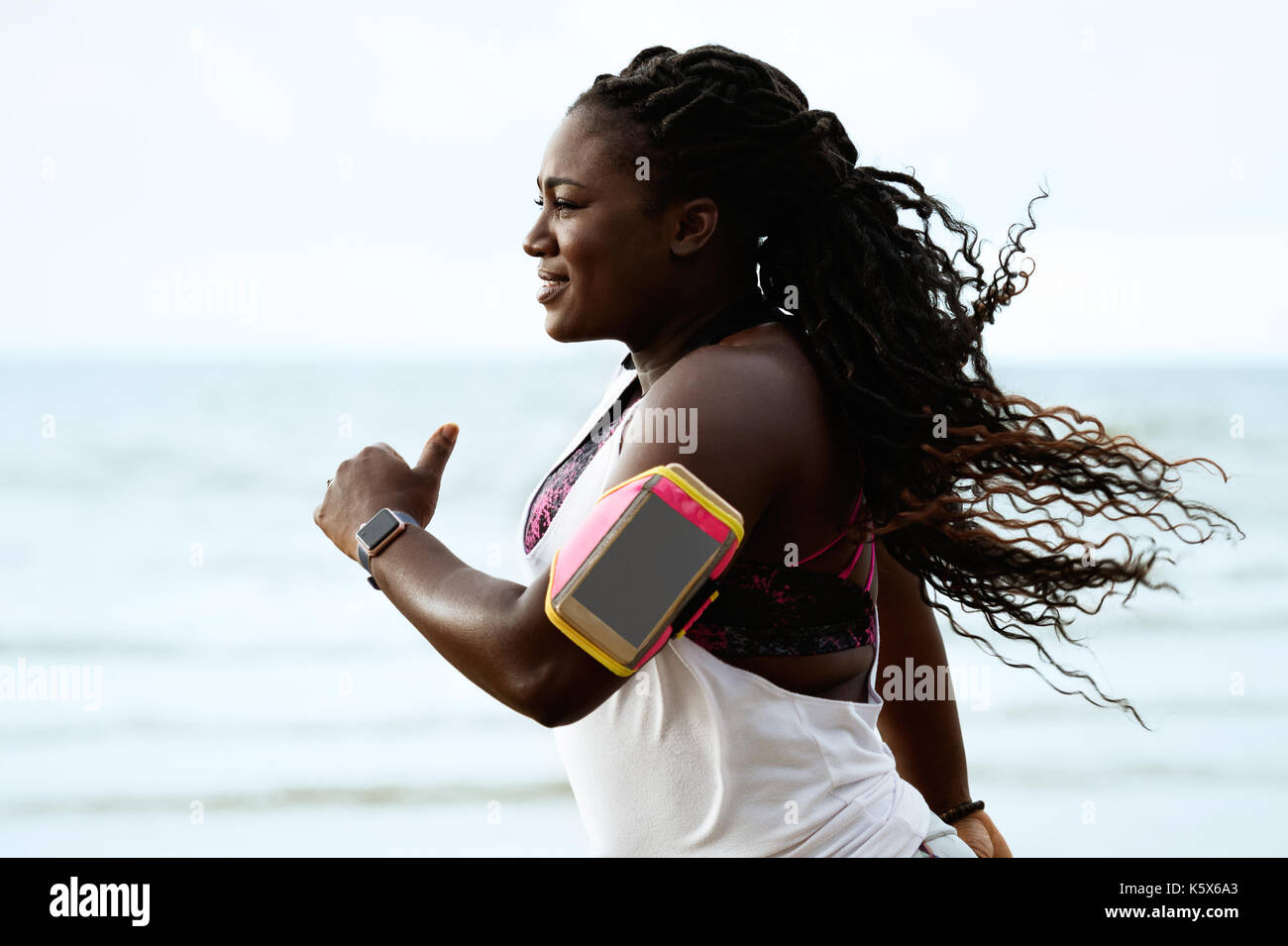 Running woman. Female african runner jogging during outdoor workout on ...