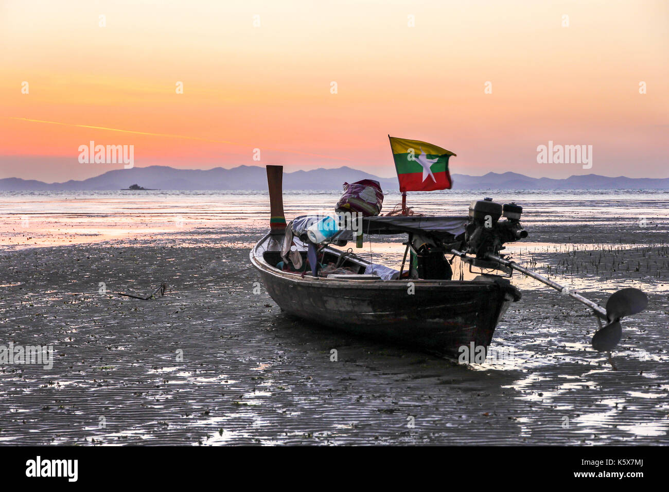 Long tail boat flying the Myanmar flag, Phang Nga Bay, Phuket, Thailand ...