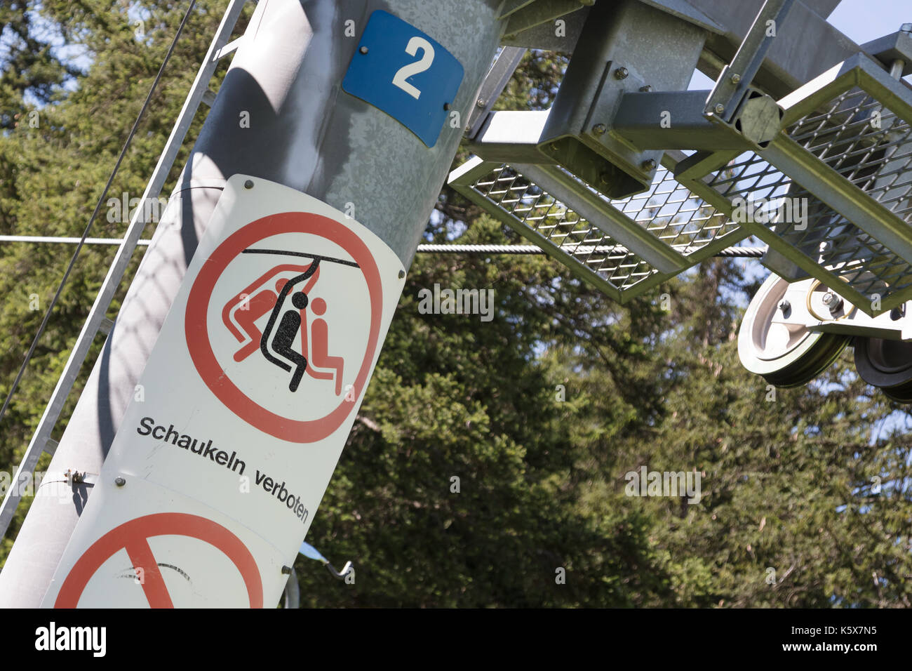 Sign in a skilift - Forbidden to swing Stock Photo - Alamy