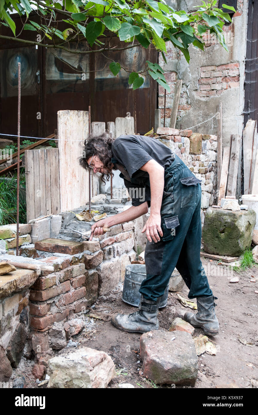 the man builds a new brick wall Stock Photo - Alamy