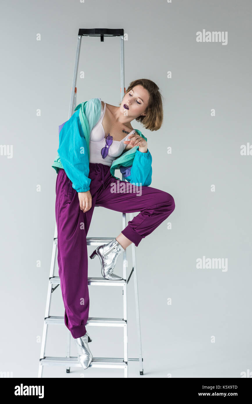 stylish woman leaning on ladder Stock Photo - Alamy