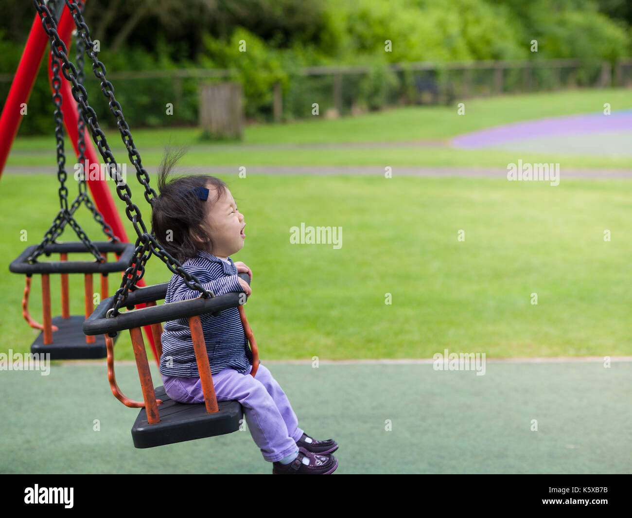 baby girl playing in the playground Stock Photo - Alamy