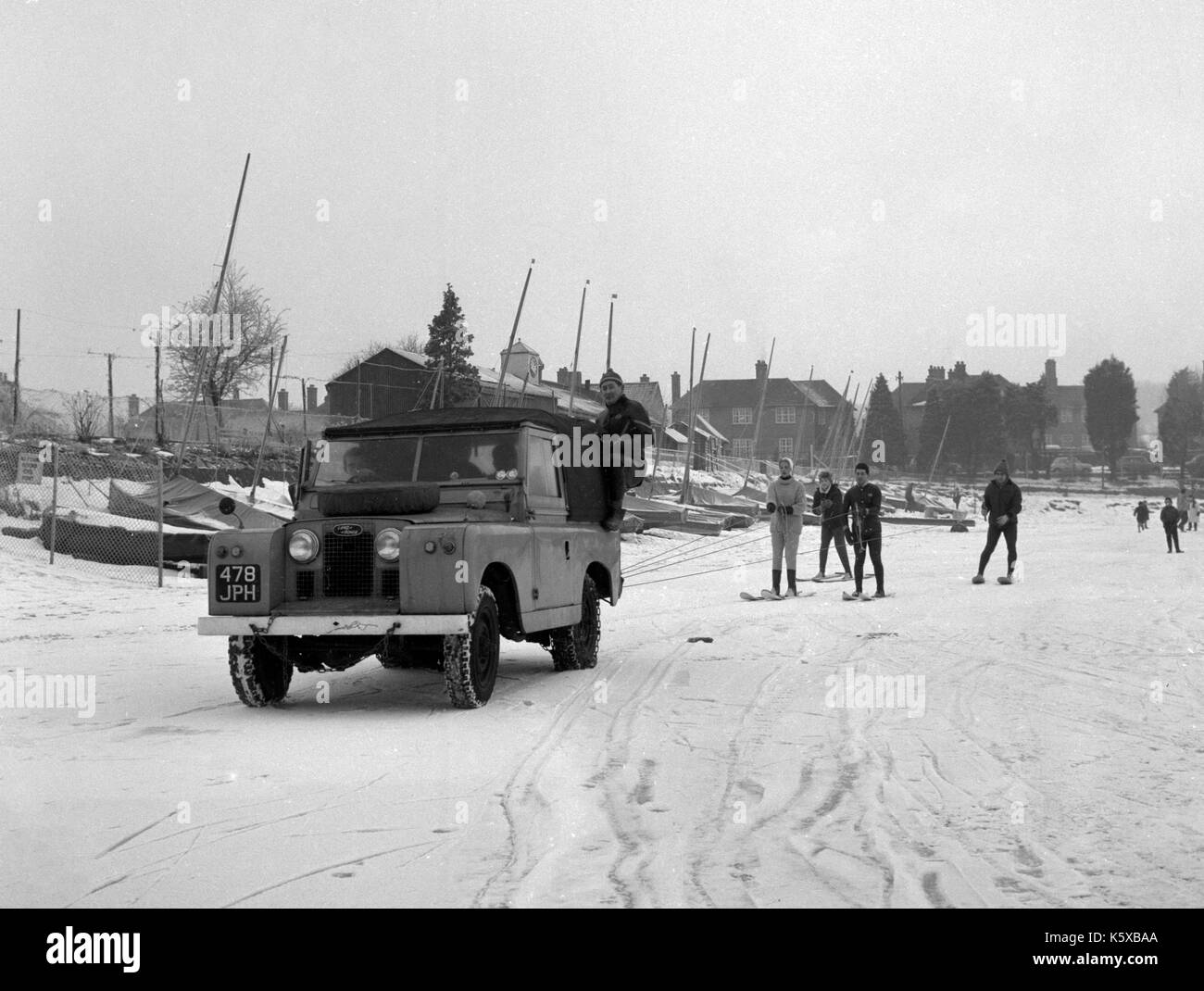A chain-equipped Land Rover pull ice skiers across thick ice of Ruislip ...