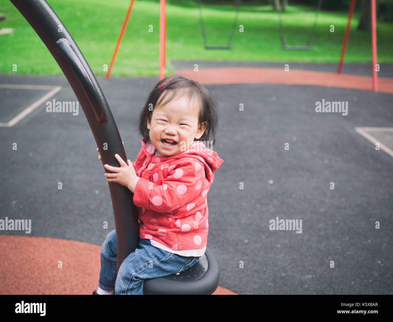 baby girl playing in the playground Stock Photo - Alamy