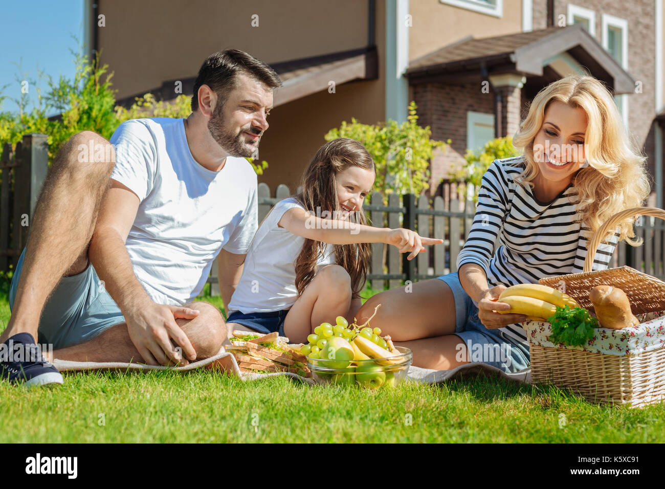 Cute girl asking her mother to give her bananas Stock Photo - Alamy