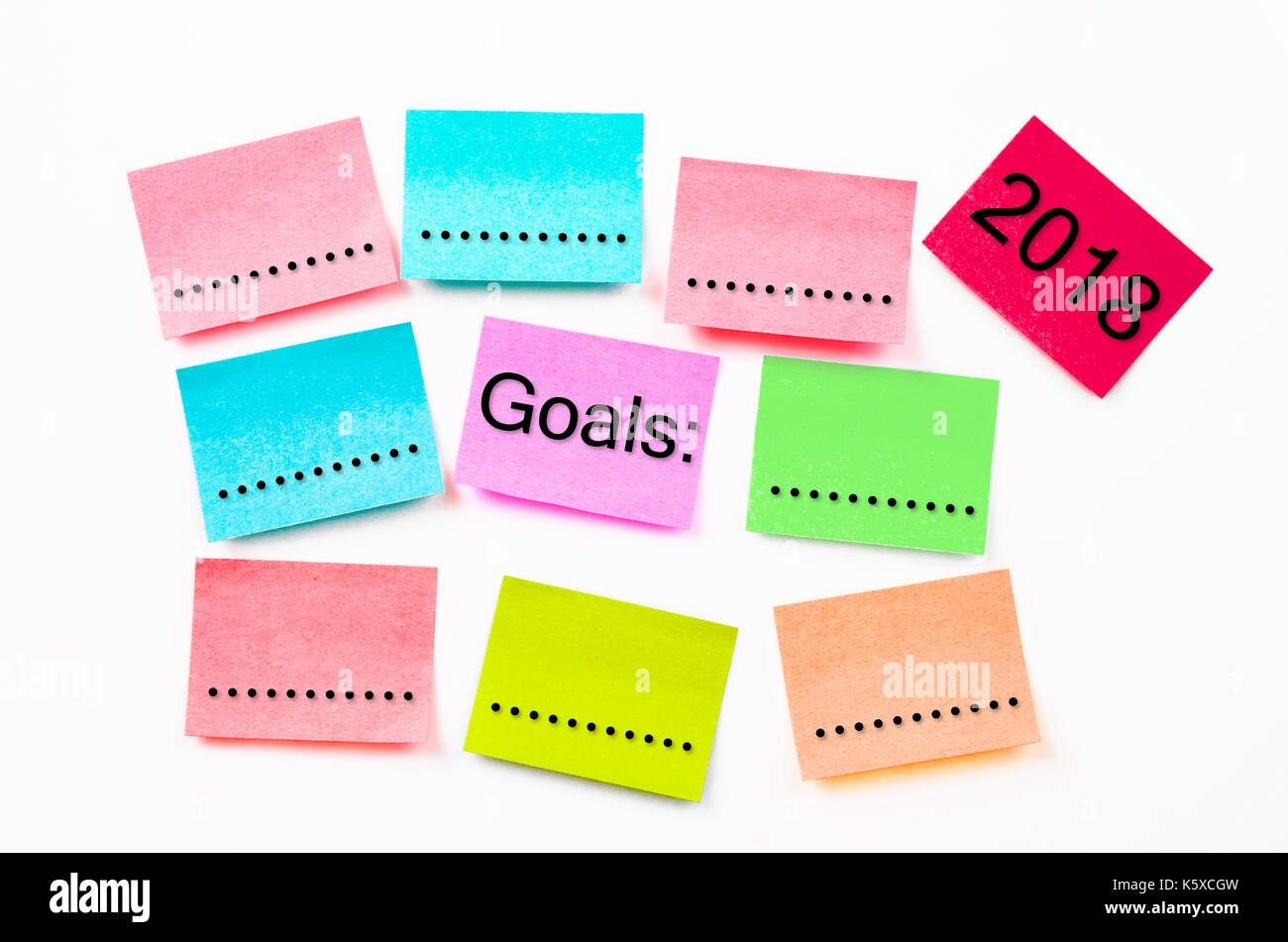 colorful sticky note paper with Goals 2018 on white wall background ...