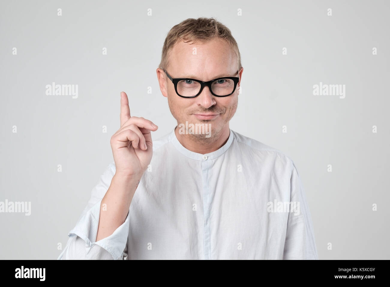 Young man pointing up High Resolution Stock Photography and Images - Alamy
