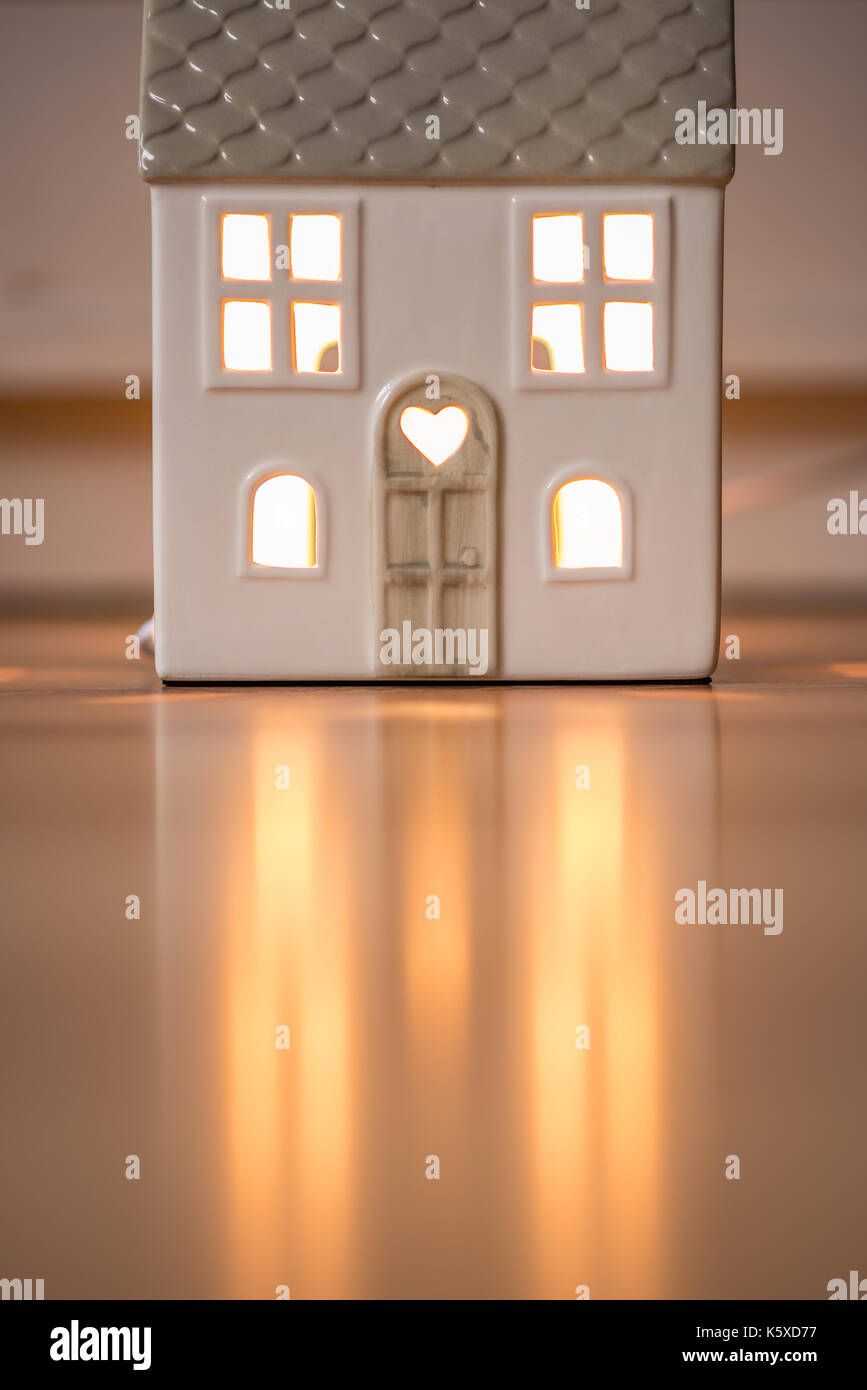 Lit up model house Stock Photo - Alamy