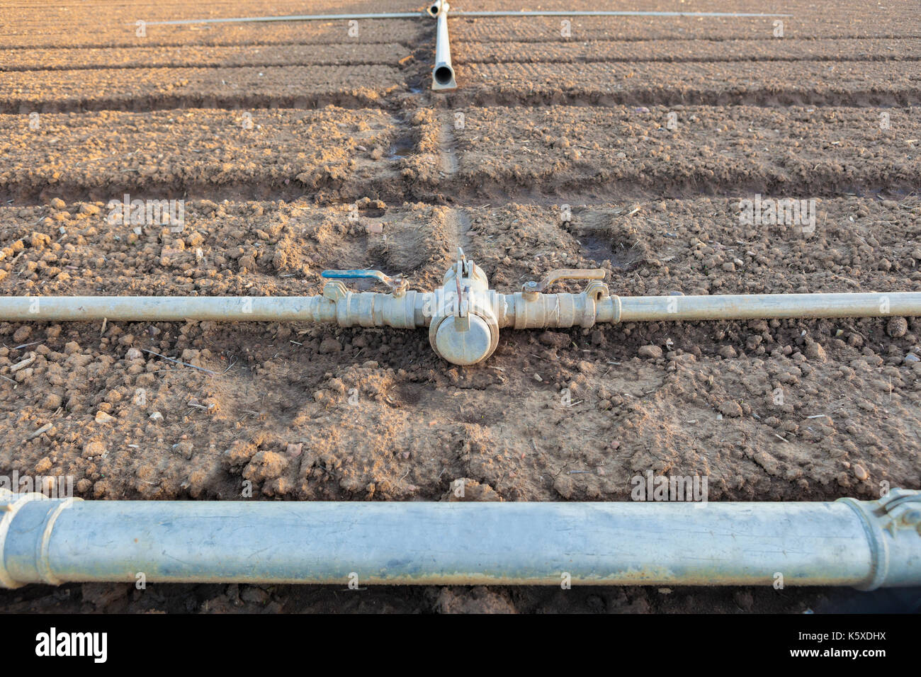Irrigation metal pipes connections on recently seeded field. Closeup ...
