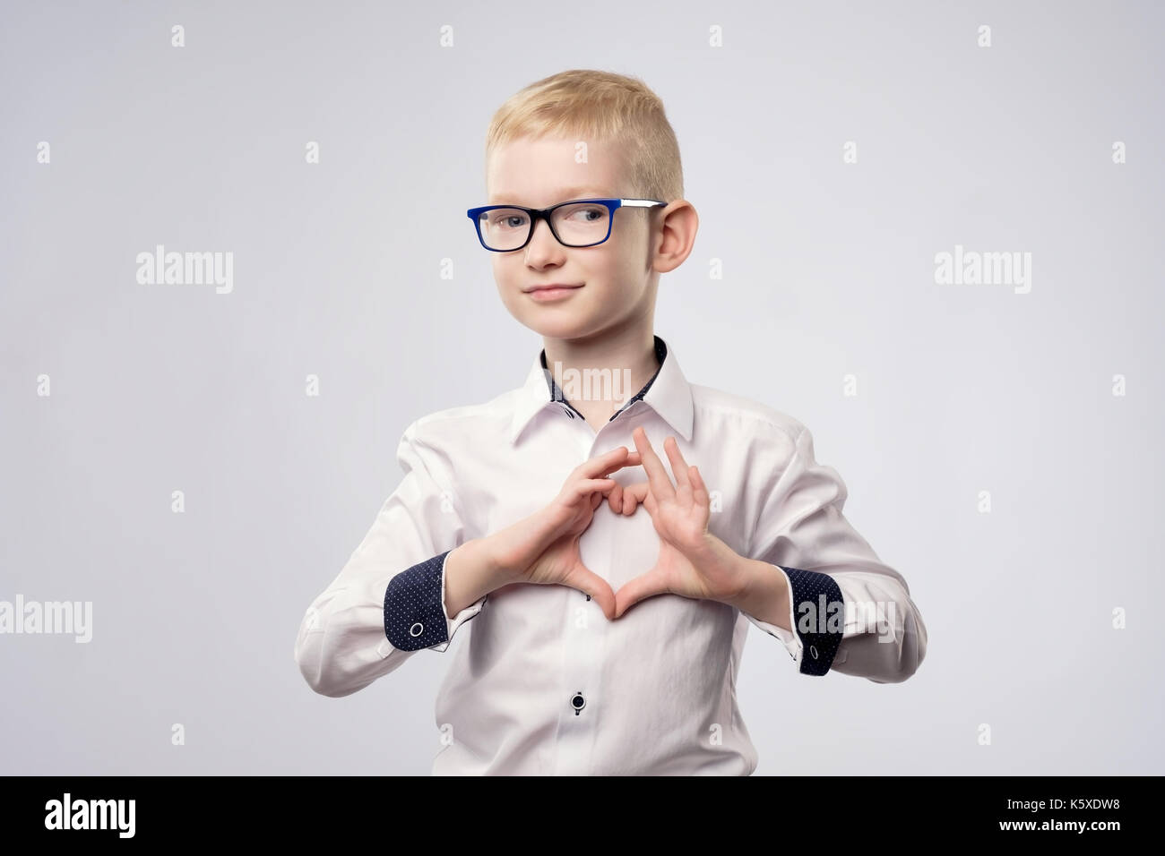 Portrait of happy boy with a heart shape isolated on white background ...