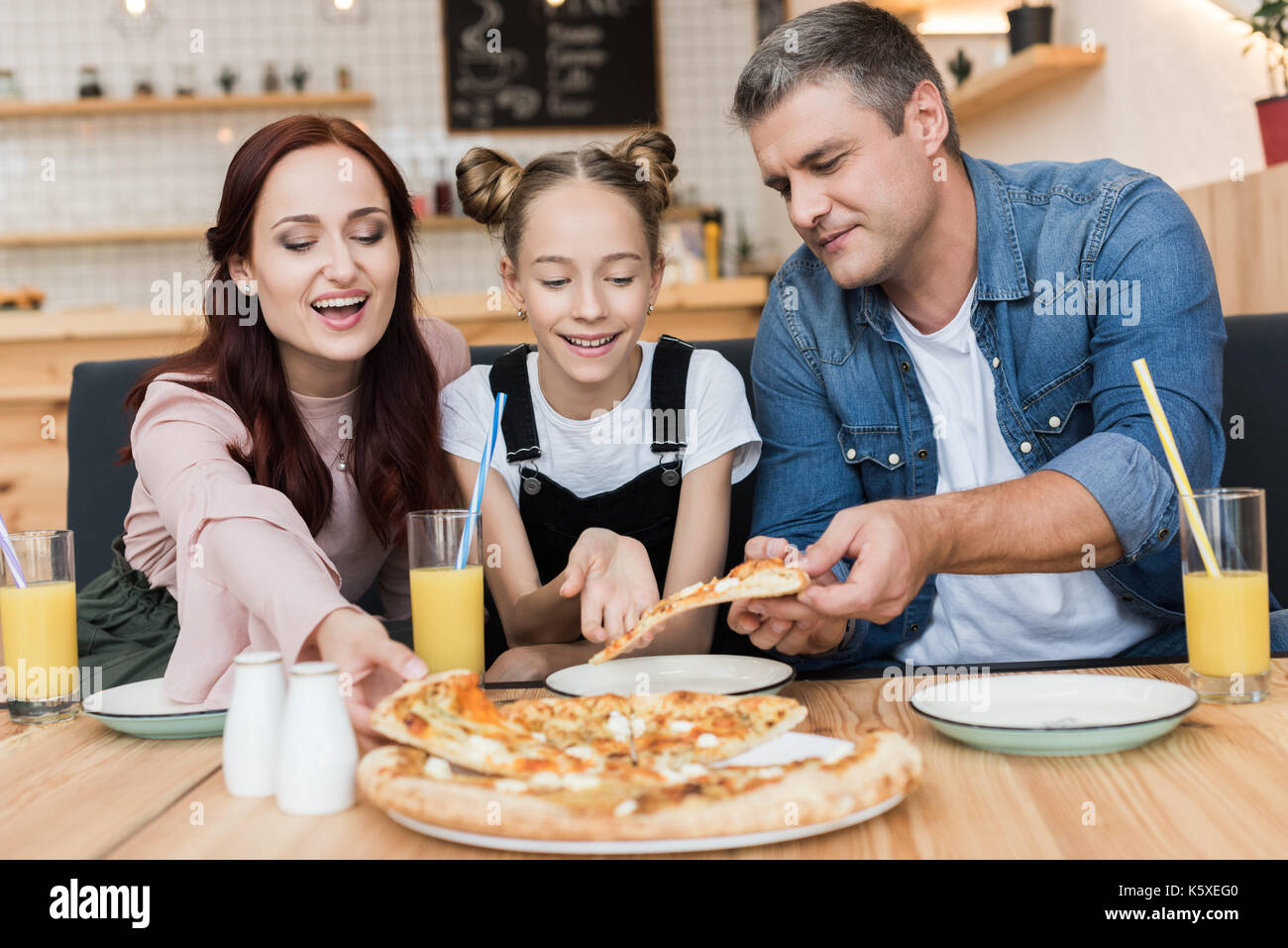 happy family eating pizza Stock Photo - Alamy