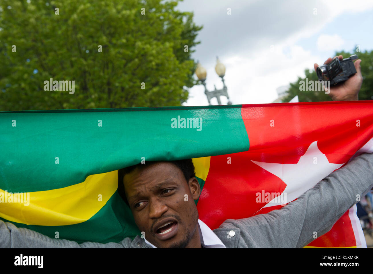 A protester displays a Togo national flag during the protest. A small ...