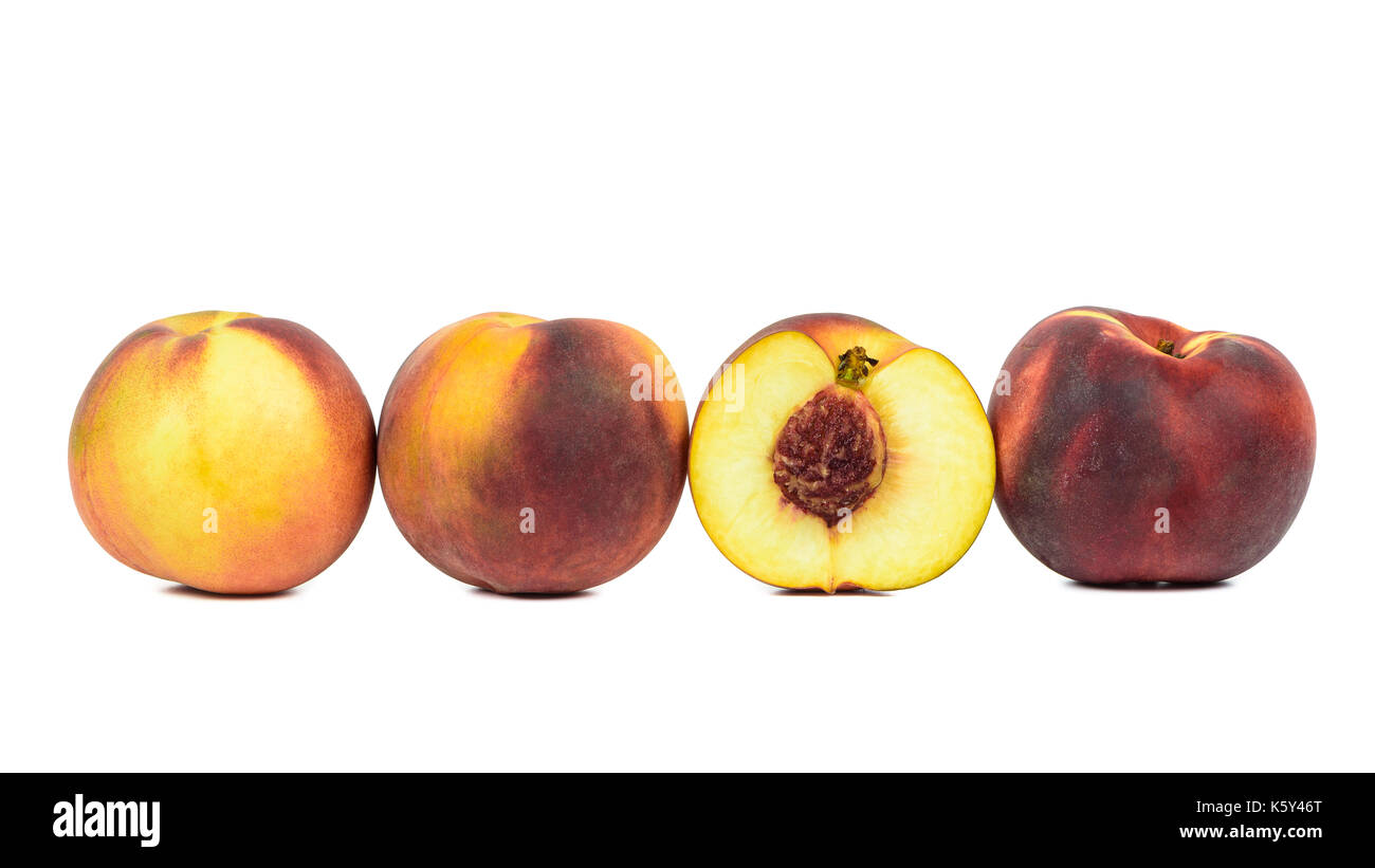 Ripe peaches in a row isolated on white background with clipping path ...