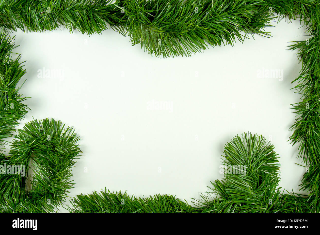 Green garland border framing white copy space for Christmas Stock Photo ...