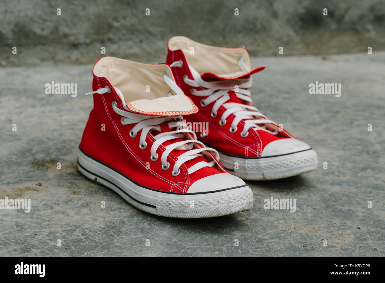 Pair of red shoes on concrete Stock Photo - Alamy