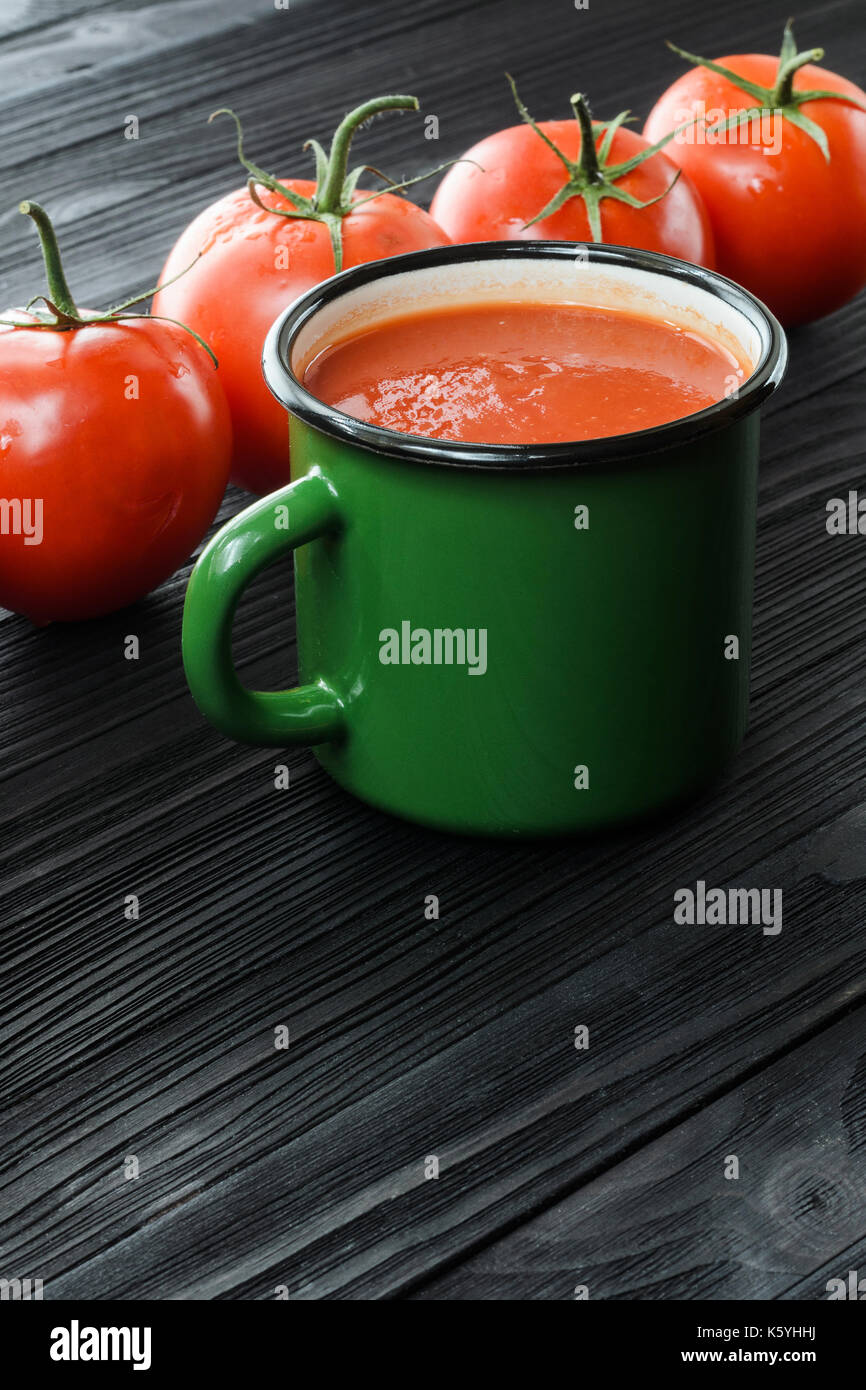 Tomato Juice in Green Enamel Mug on a Black Wooden Table Among Fresh ...