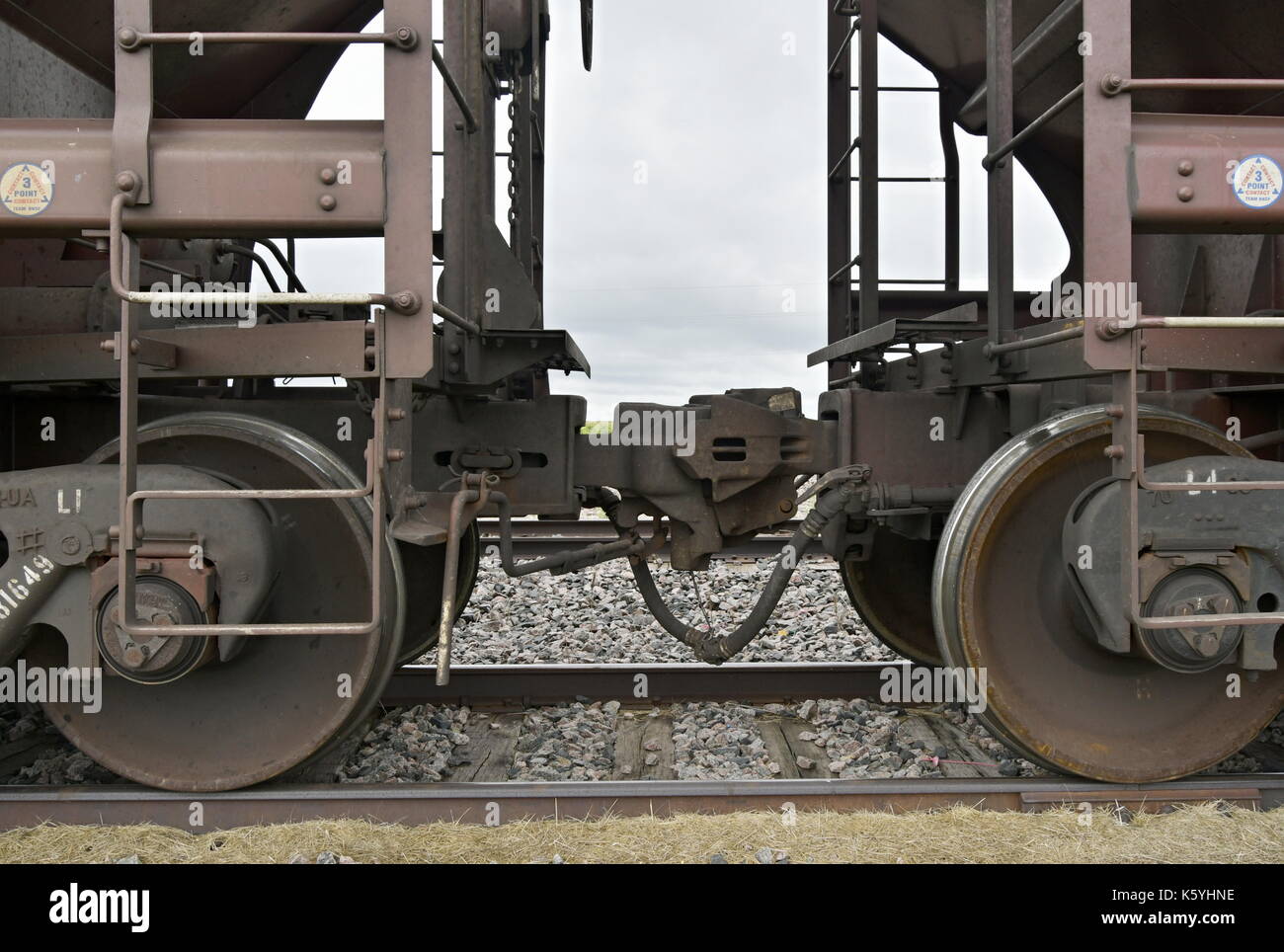Coupling between two railway cars on tracks Stock Photo - Alamy