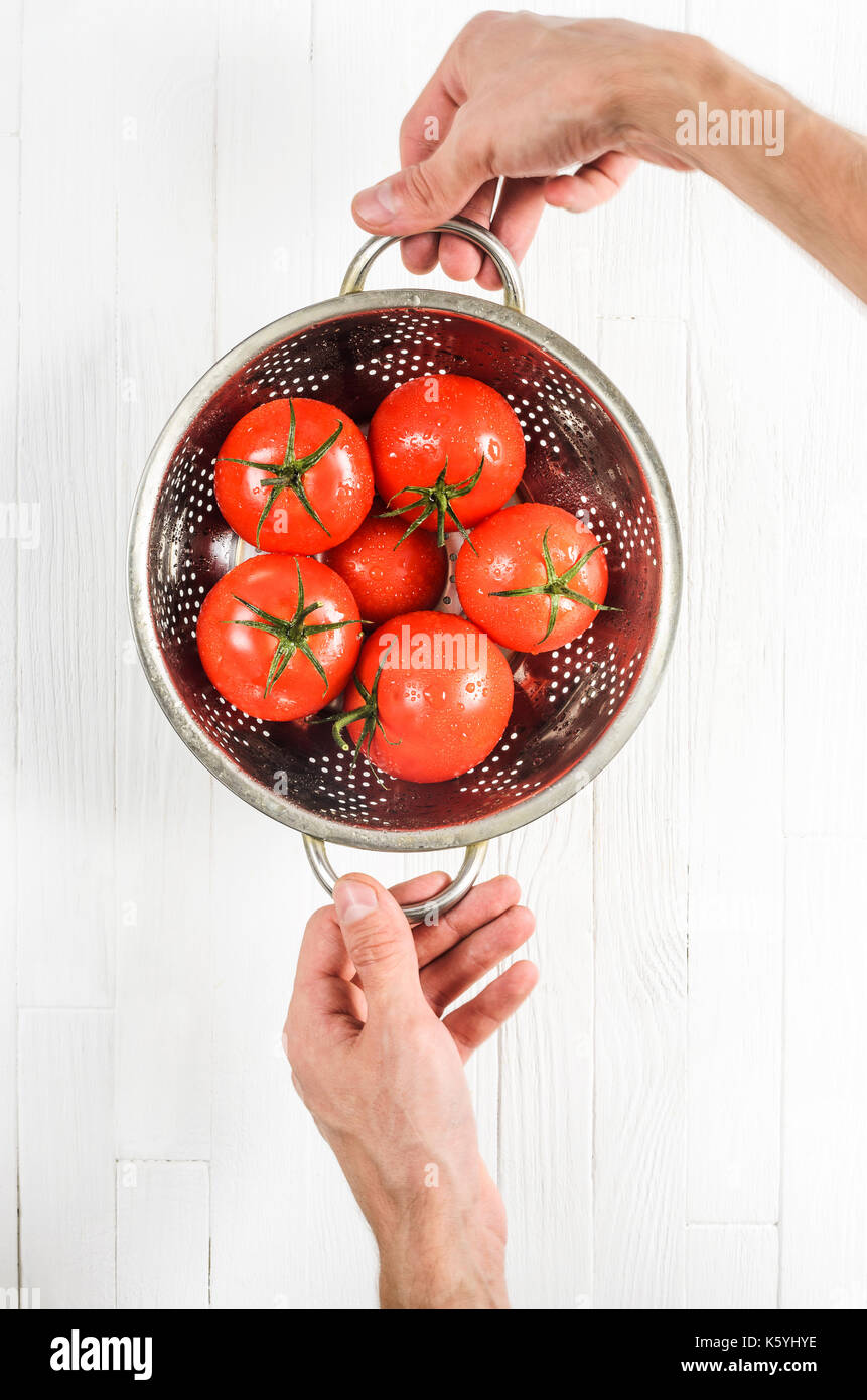 Stainless Steel Colander with Wet Tomatoes in a Chefs Hands After ...