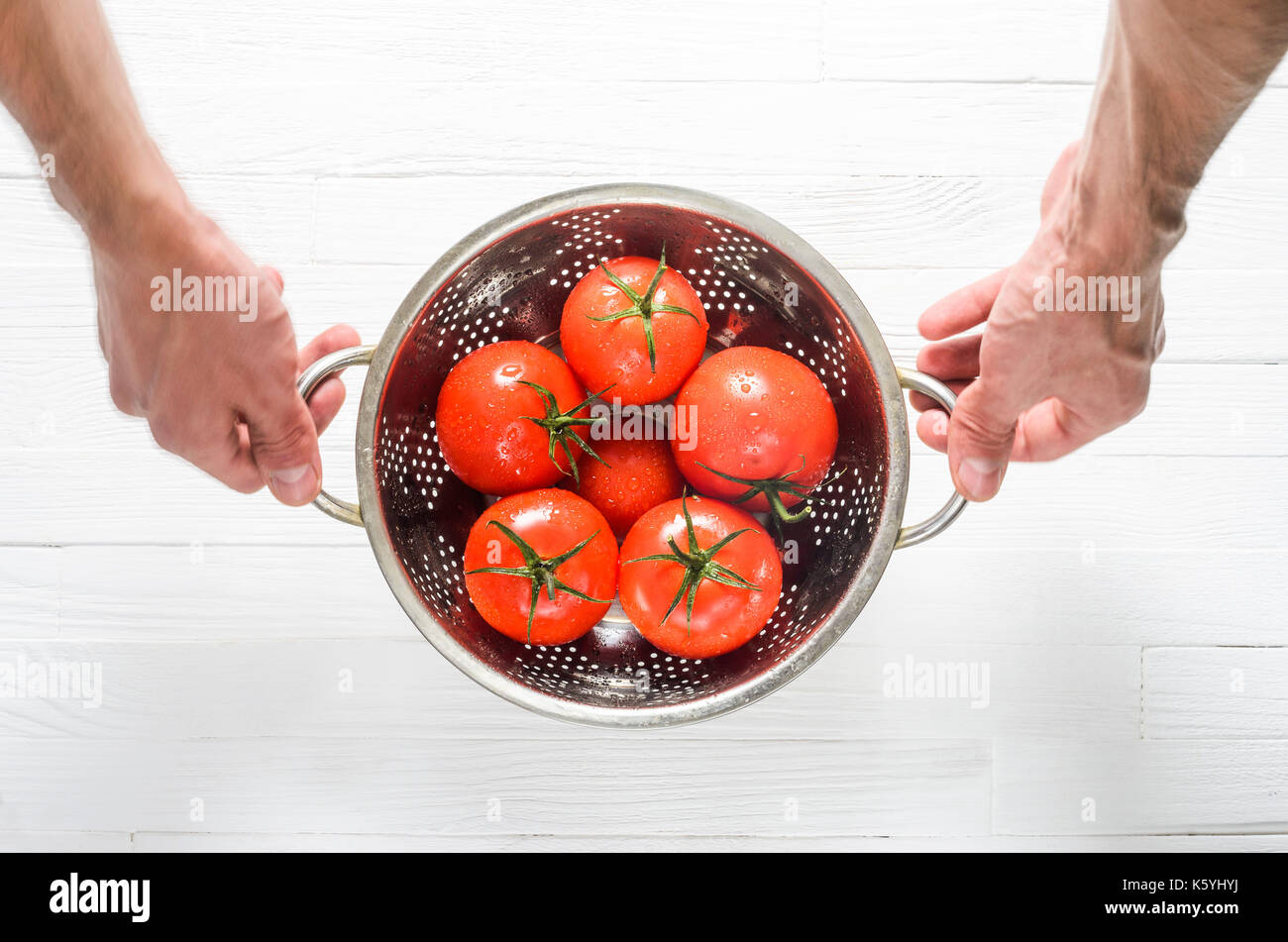Stainless Steel Colander with Wet Tomatoes in a Chefs Hands After ...