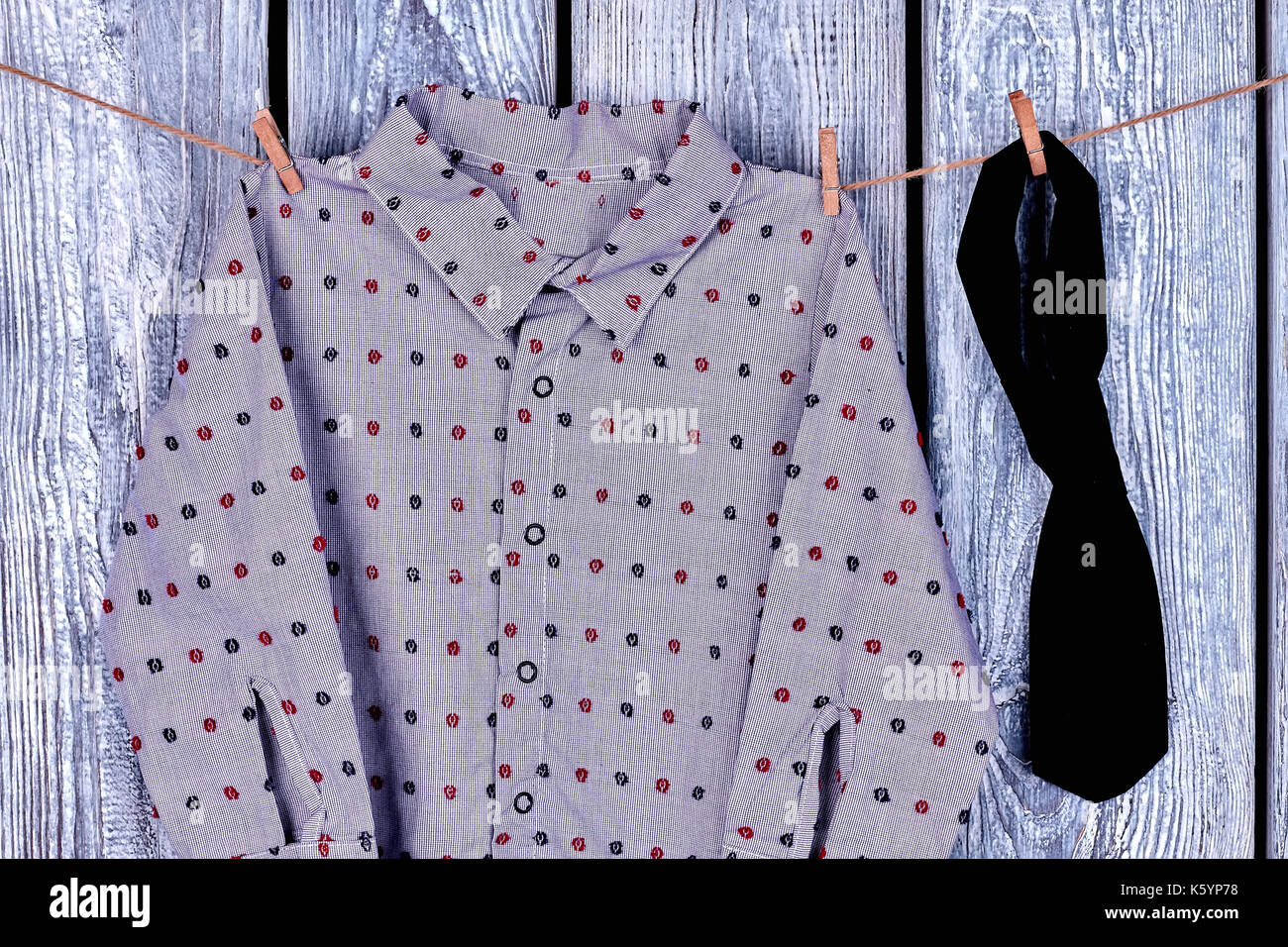 Boys garment hanging on rope. Clothesline with hanging baby boy clothes ...