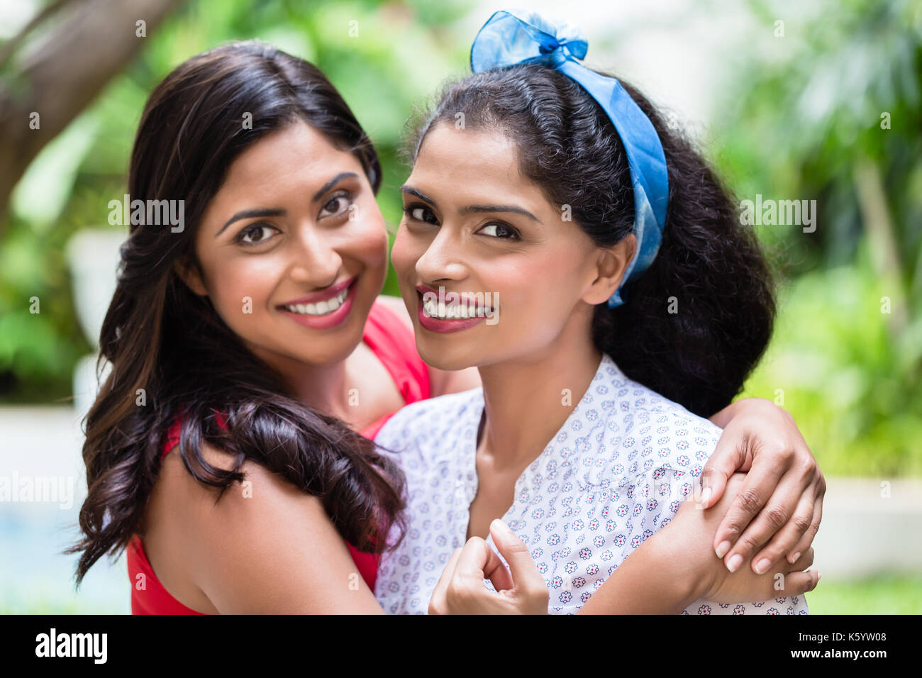Close-up portrait of two young women posing together as best friends ...