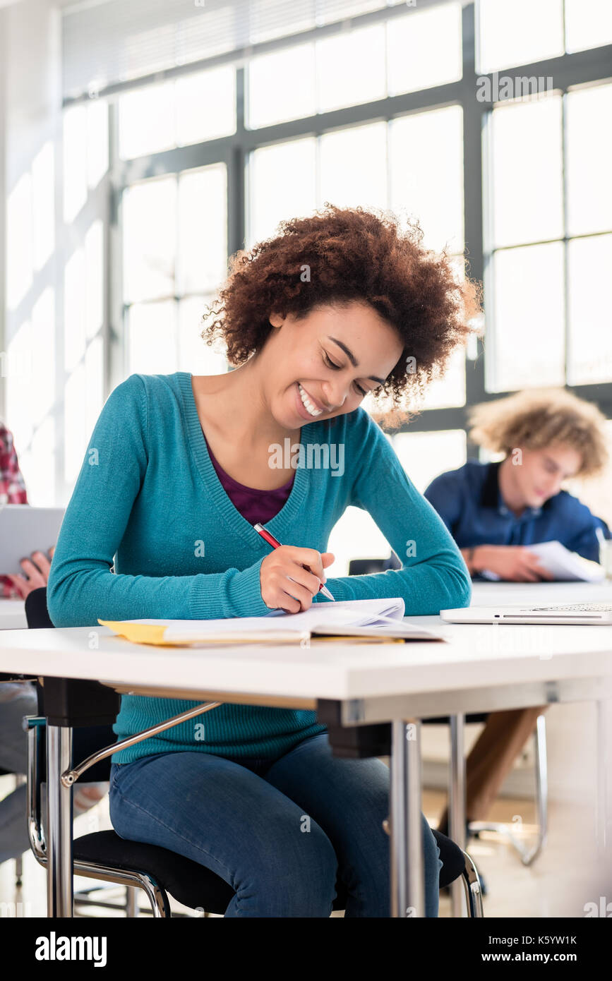 Young female student with a serious facial expression concentrating ...