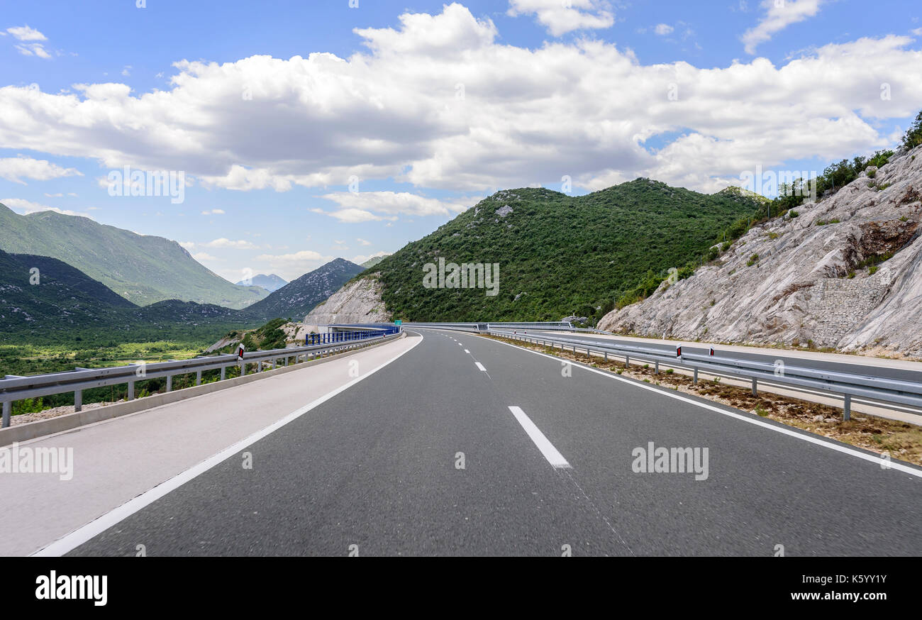 High-speed country road among the mountains Stock Photo - Alamy