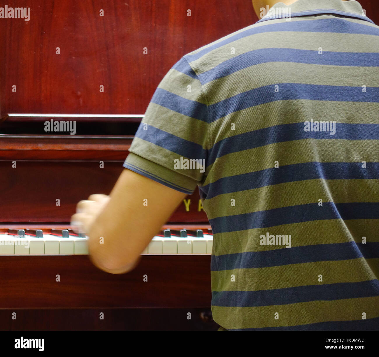 Back view of music performer playing piano at luxury hotel Stock Photo ...