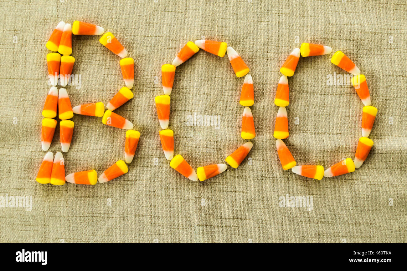 candy corn spelling BOO isolated on tan cloth background Stock Photo ...